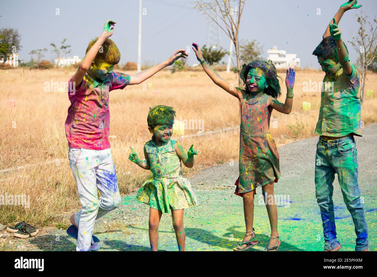 Group of Kids with colors applied dancing during holi festival ...