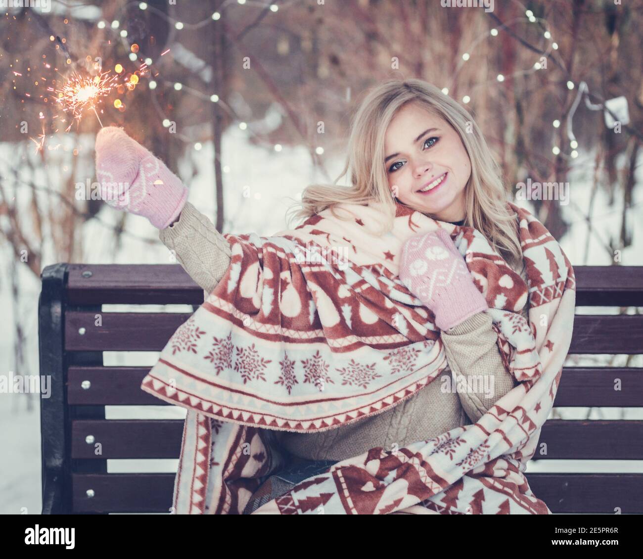 portrait-of-young-attractive-celebrating-woman-holding-sparkles-stock