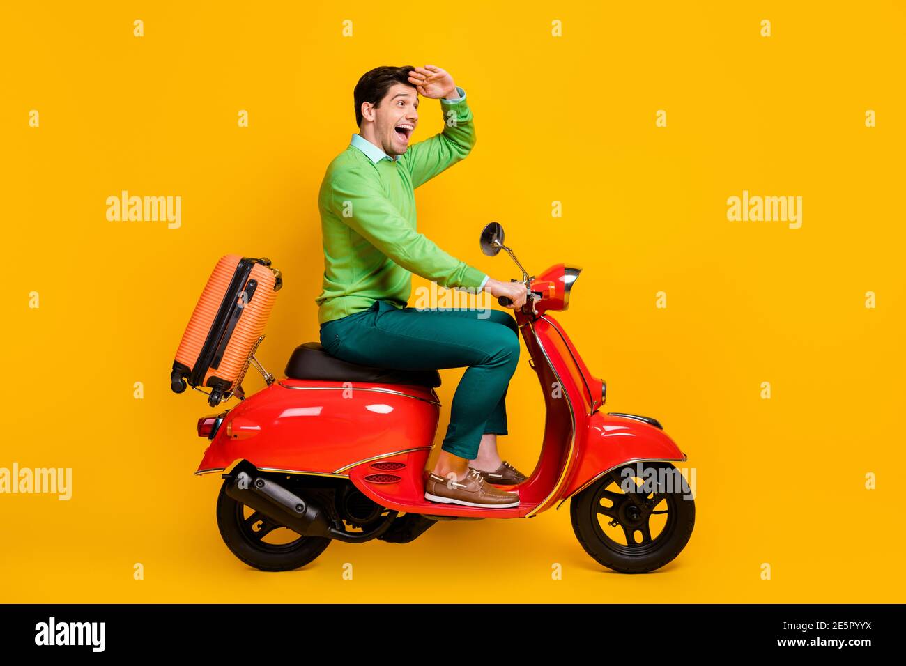 Full body profile portrait of crazy guy driving moped arm on forehead ...