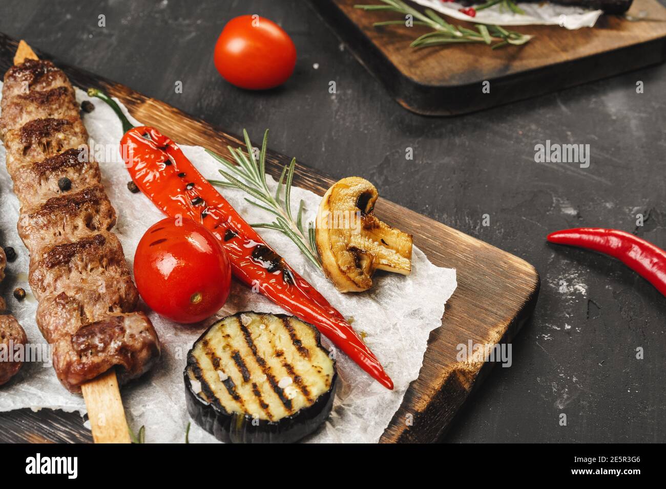 Grilled Lula kebab on skewers served on wooden board Stock Photo - Alamy