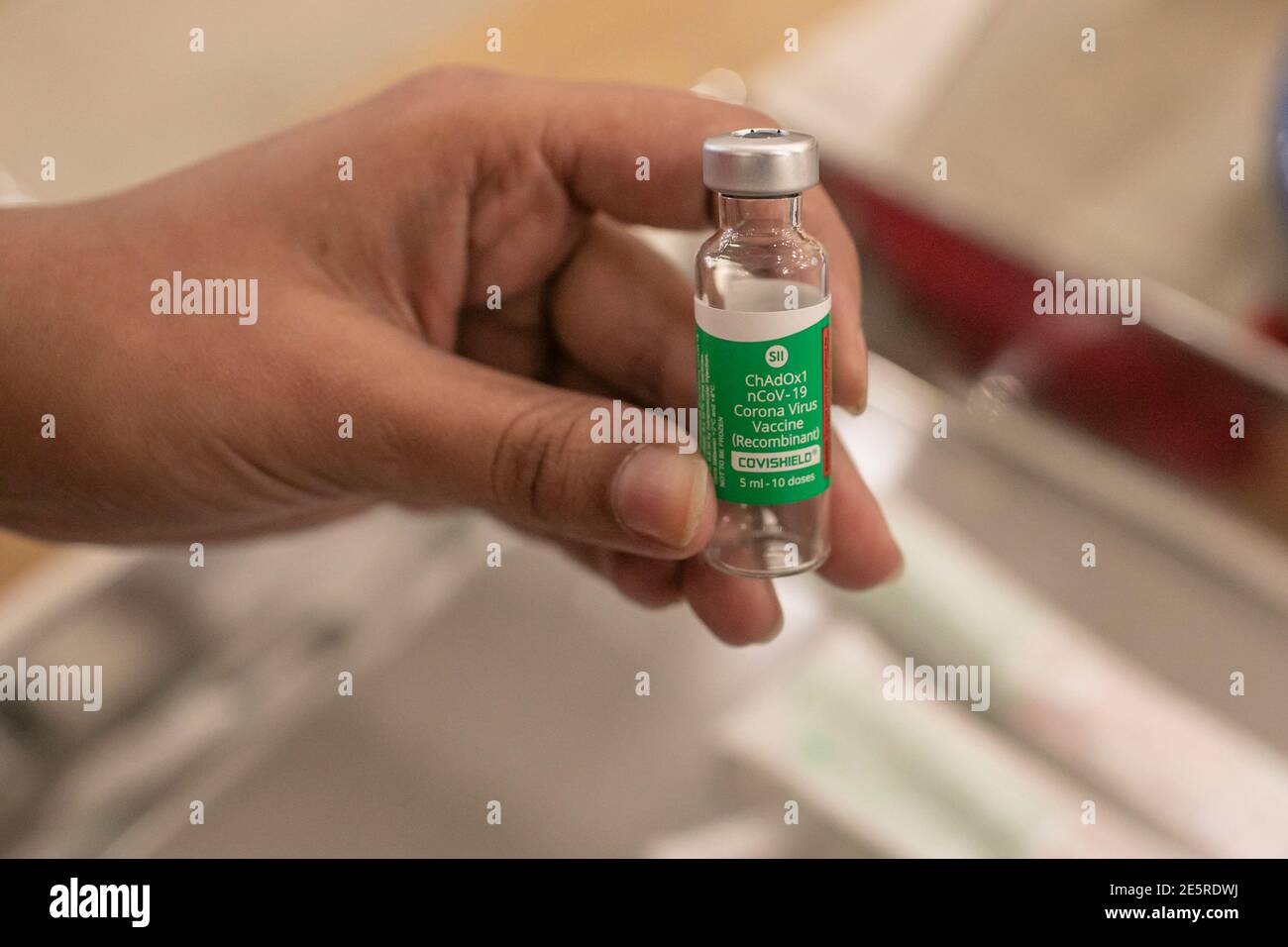 Dhaka, Bangladesh. 28 Jan 2021: A health worker shows a vial of Oxford ...