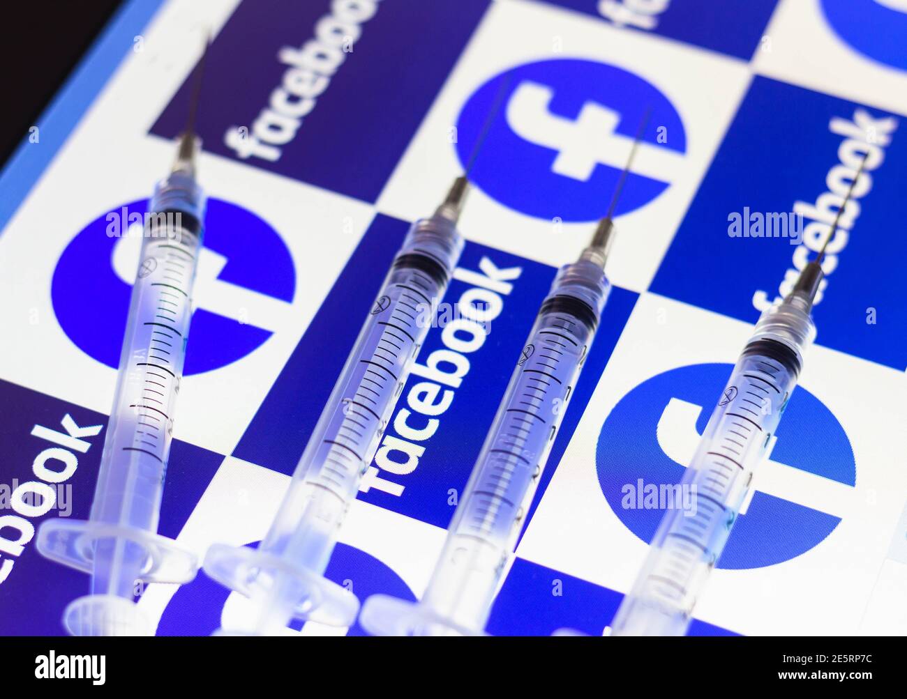 In this photo illustration various medical syringes seen with Facebook ...