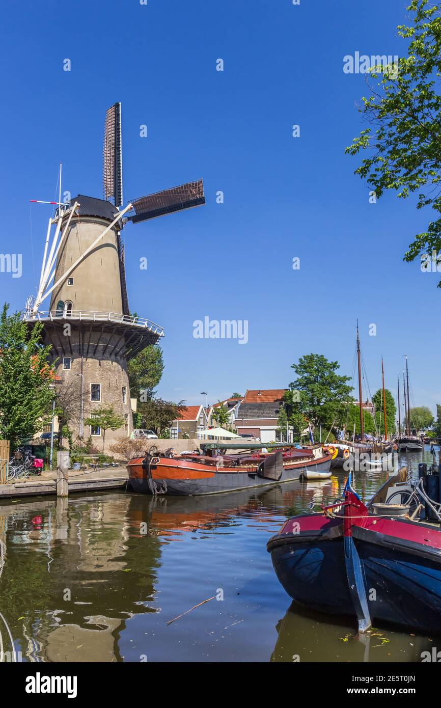Harbor with traditional sailing ships and wind mill hi-res stock ...