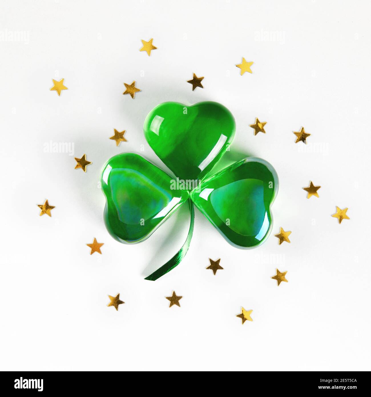 Shamrock symbol made of green glass hearts lying on white background ...