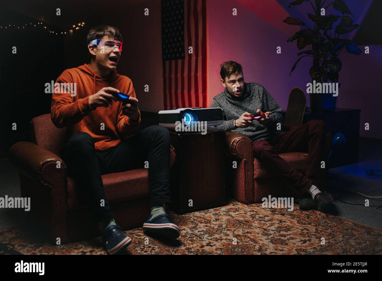 Cheerful gamers with joysticks playing video game Stock Photo - Alamy