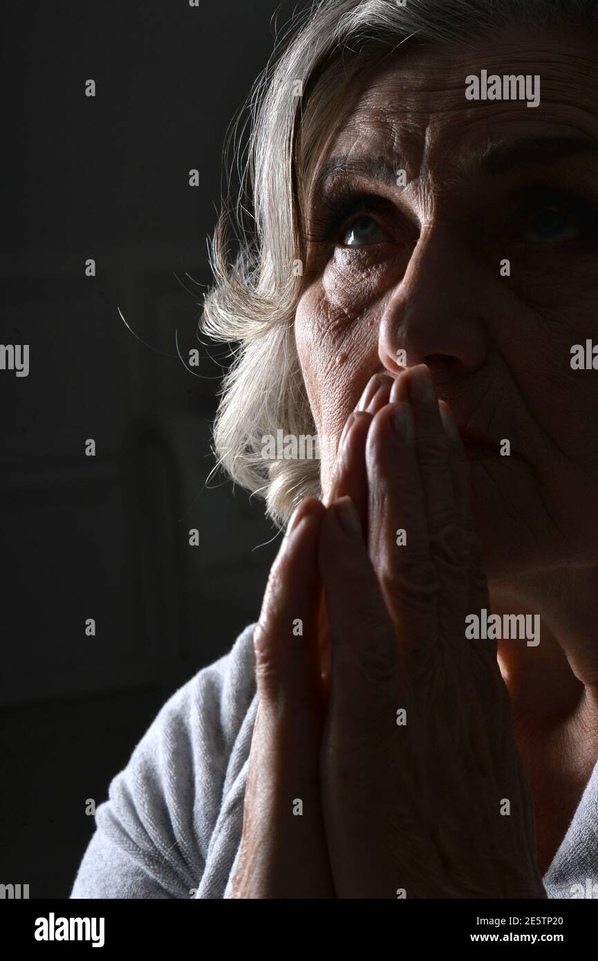 Elderly lady praying hi-res stock photography and images - Alamy