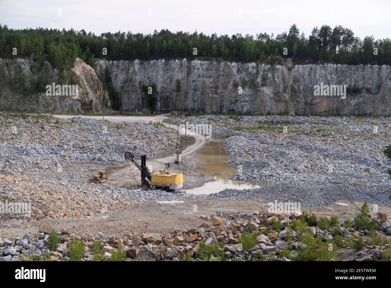 View inside granite quarry with heavy yellow machine. Mining equipment ...