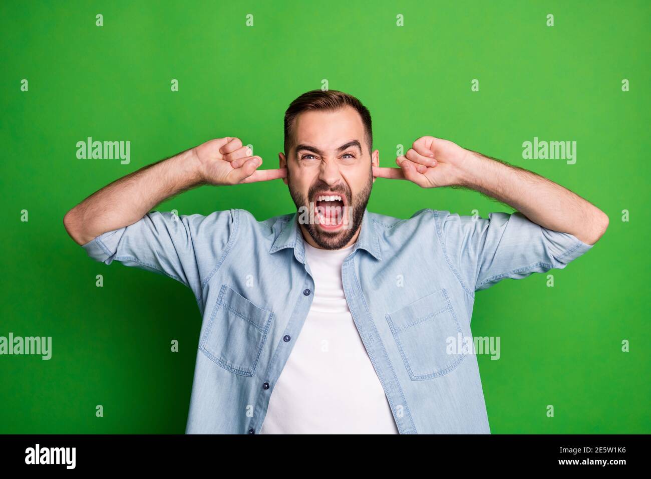 Portrait of angry guy hands ears yell wear blue shirt isolated on ...
