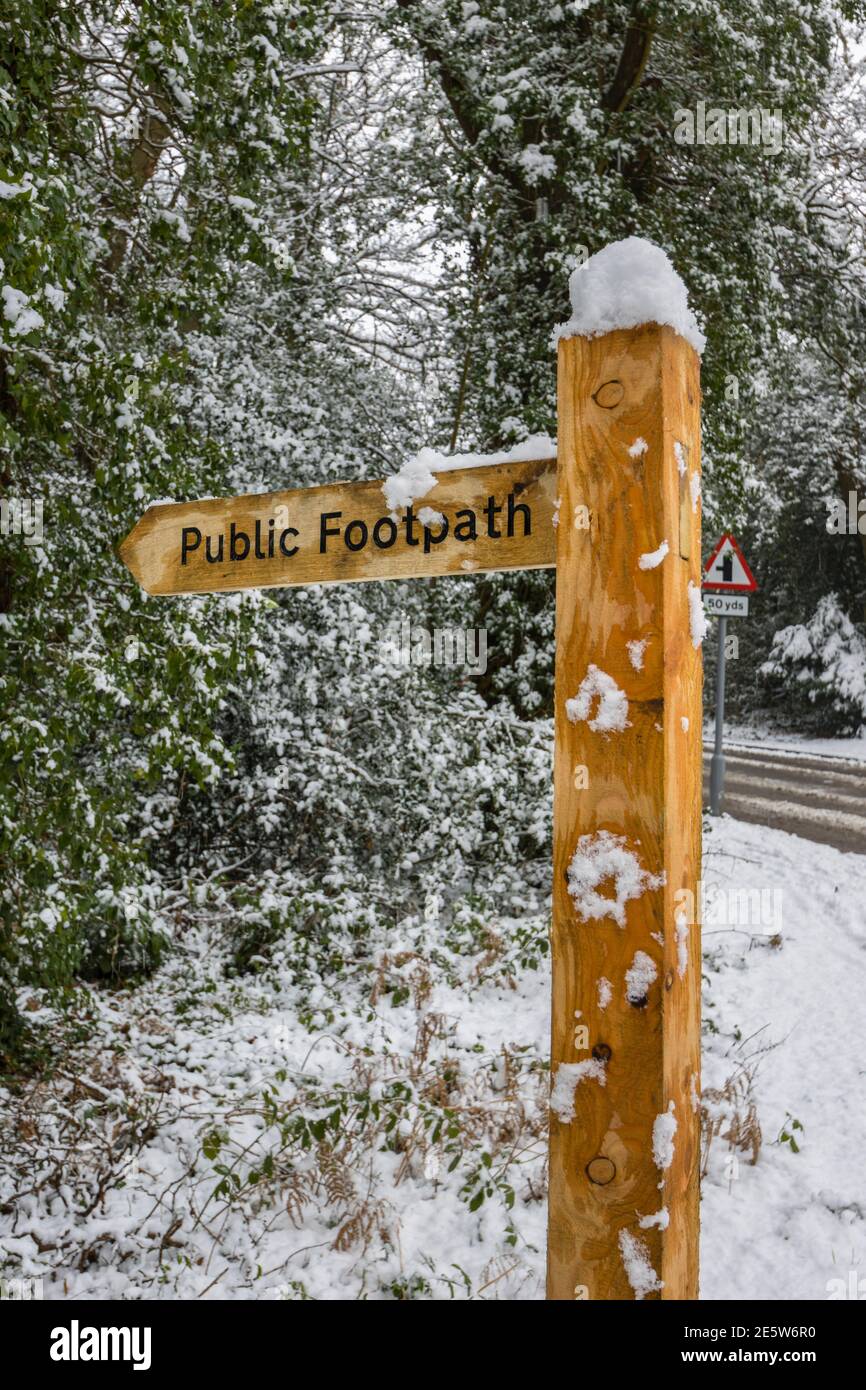 New wooden public footpath fingerpost signpost with snow after a heavy ...