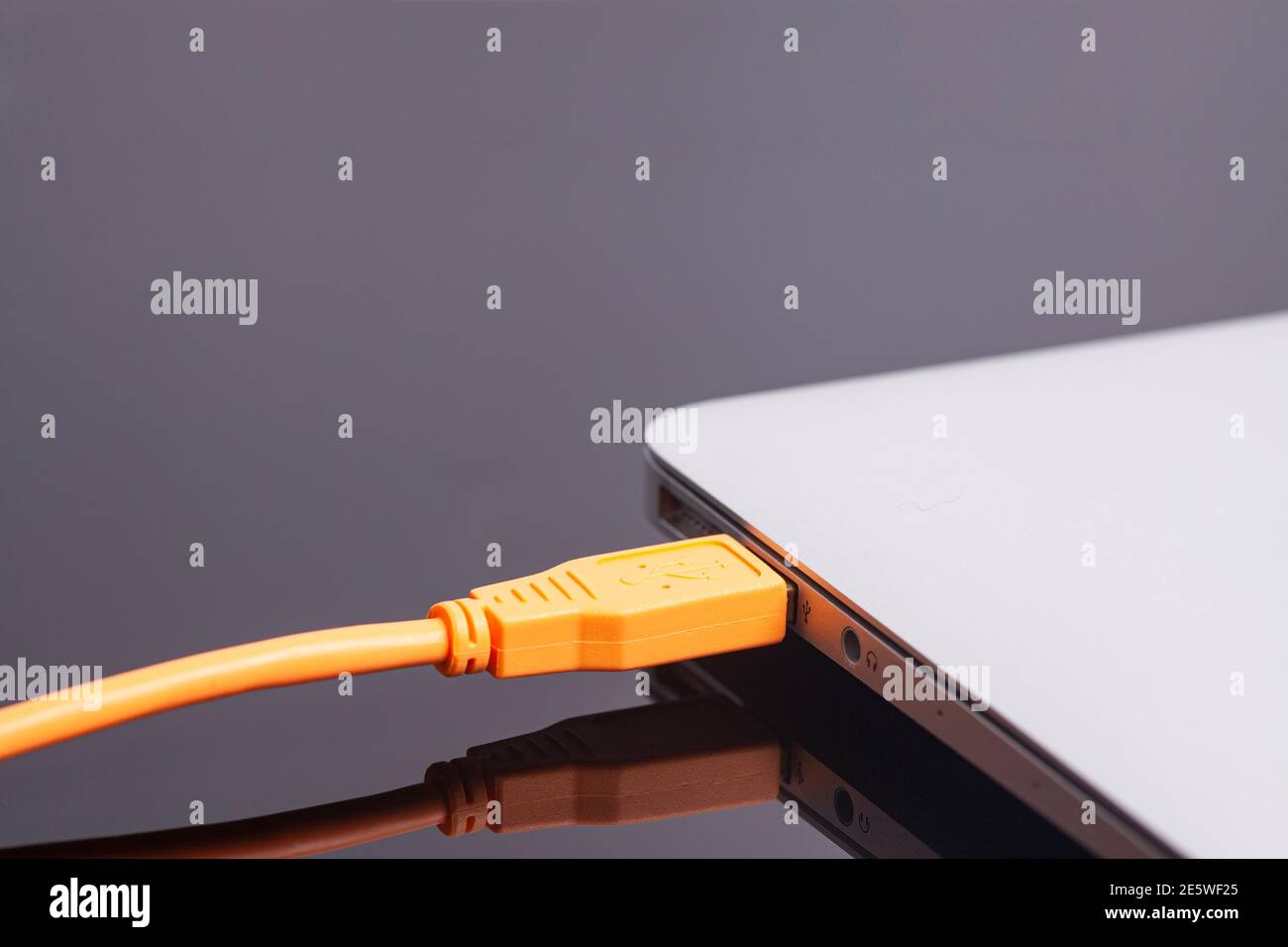 laptop with USB orange cable Stock Photo - Alamy