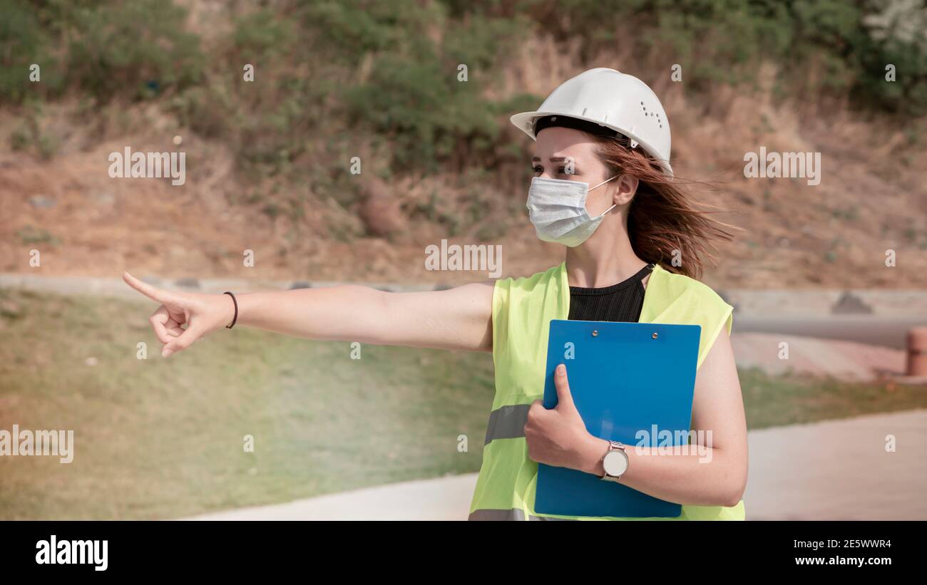 Female employee standing pointing hand hi-res stock photography and ...