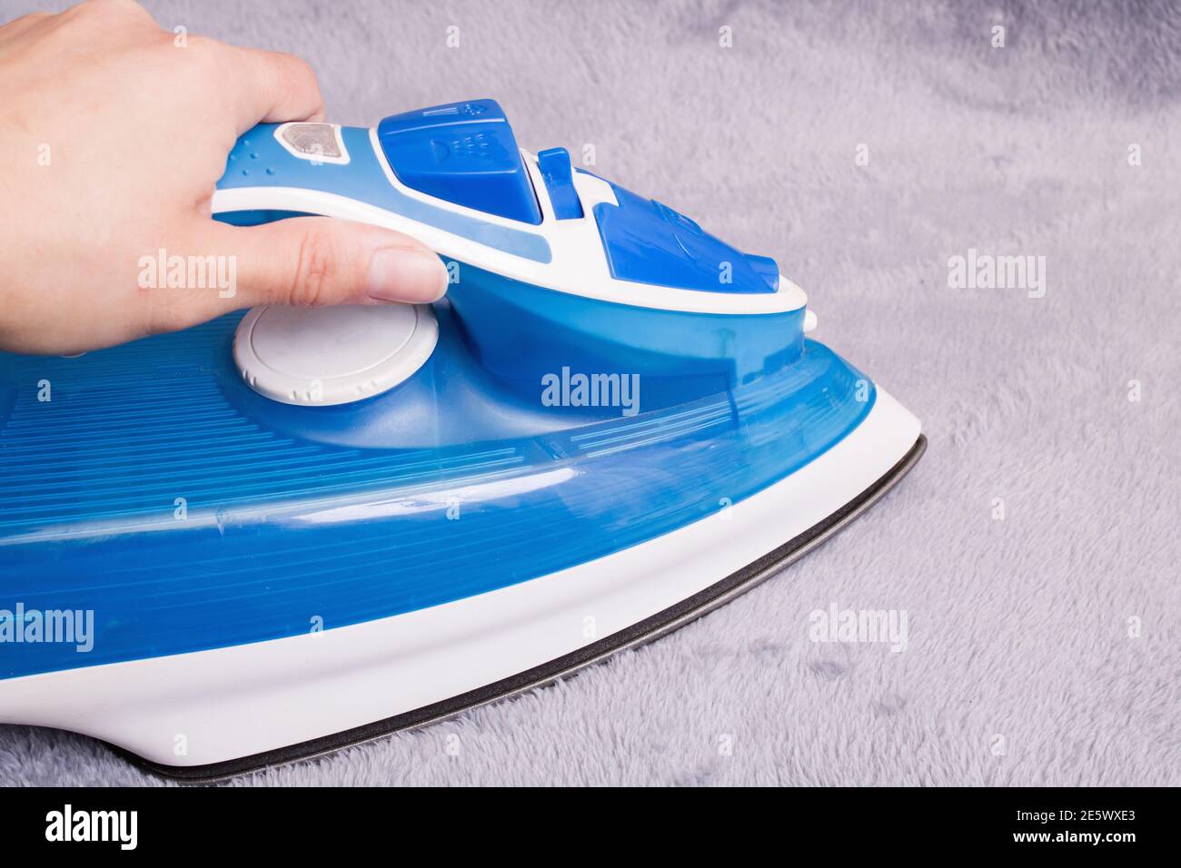 Women hand hold iron hi-res stock photography and images - Alamy