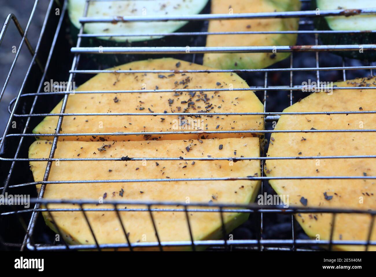 Pieces of pumpkin on a barbecue grill Stock Photo - Alamy