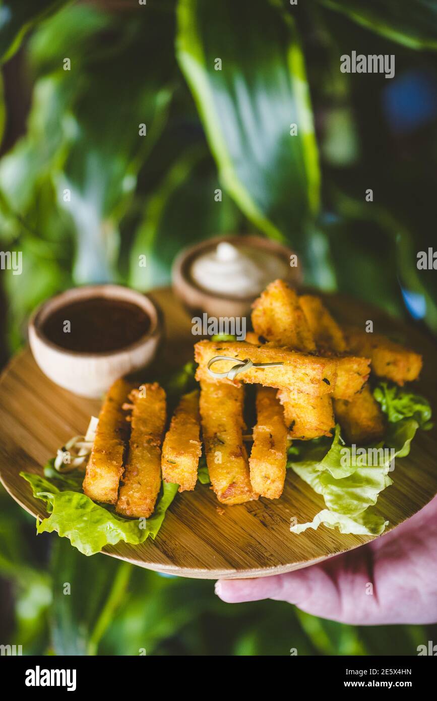 Vertical shot of tasty sticks with lettuce and sauces on the side Stock ...