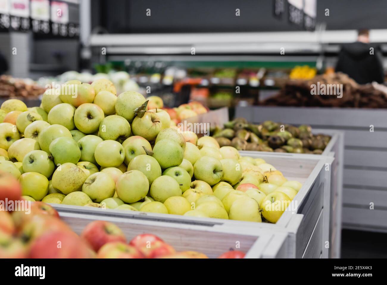 Fresh apples near groceries on blurred background in supermarket Stock ...