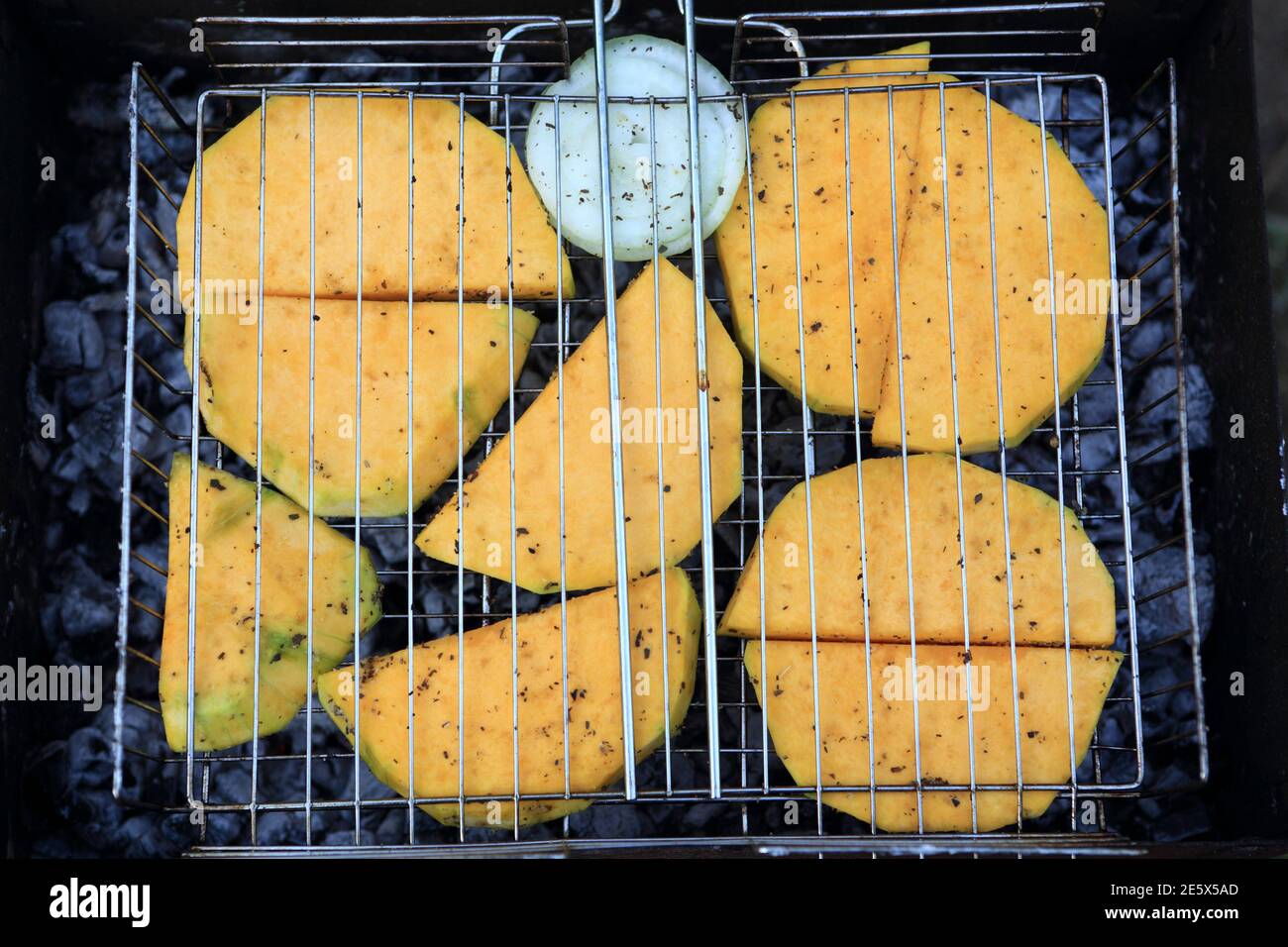 Cooking of pumpkin on a barbecue grill Stock Photo - Alamy