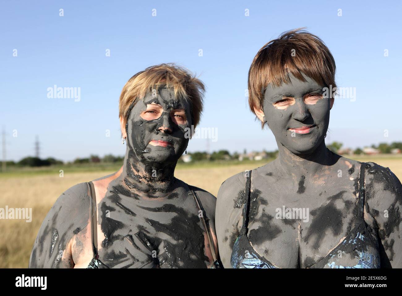 Two women covered mud at the firth Stock Photo - Alamy