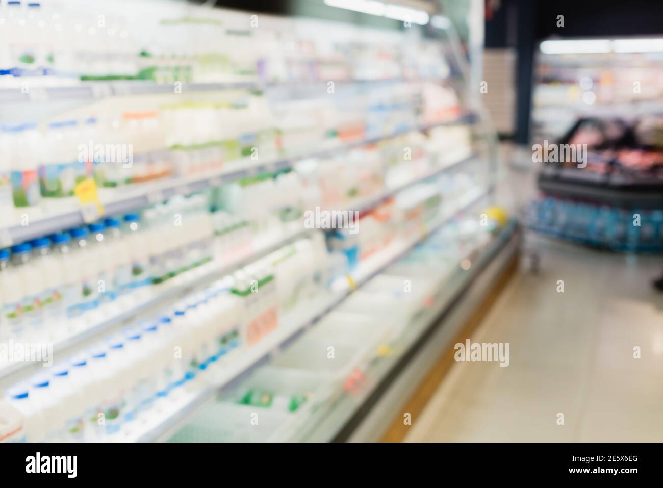 Blurred background of groceries on counters in store Stock Photo - Alamy