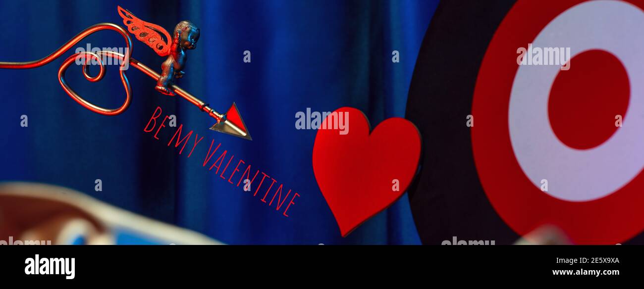 Small golden cupid marks his target with an arrow at the heart ...