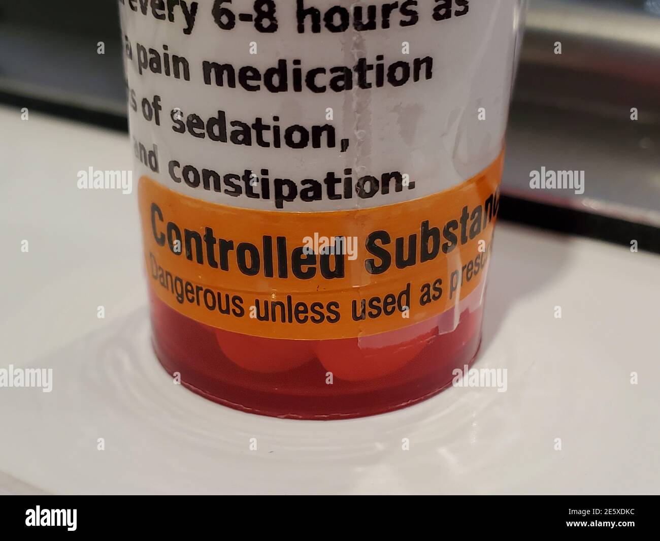 Close-up of a pain medication bottle featuring the warning "Controlled ...