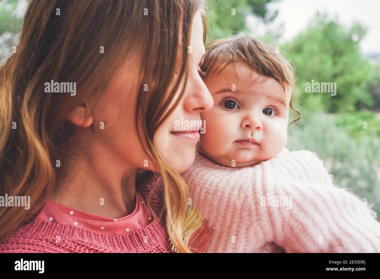 Young mother hugging her baby Stock Photo - Alamy