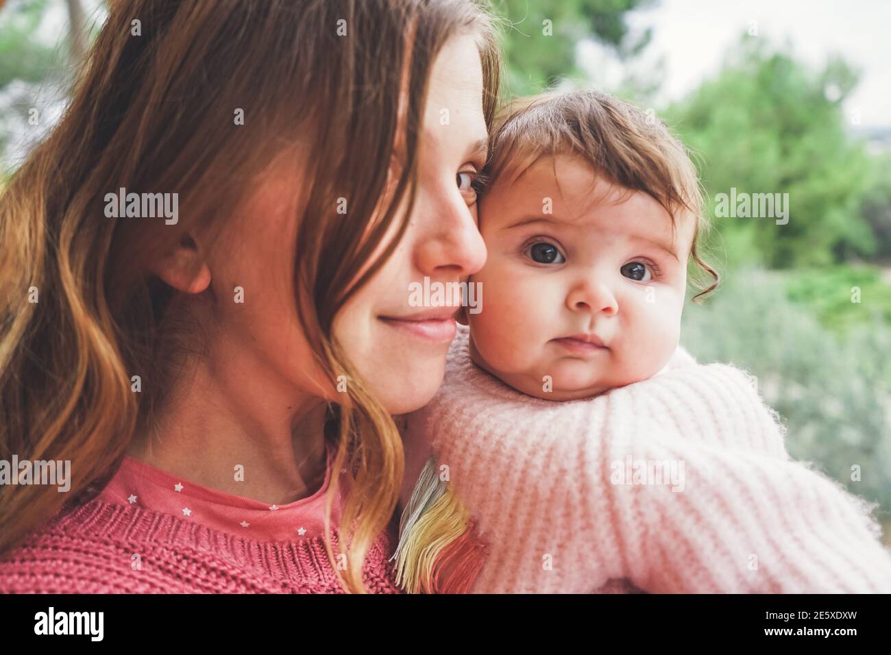 Young mother hugging her baby Stock Photo - Alamy