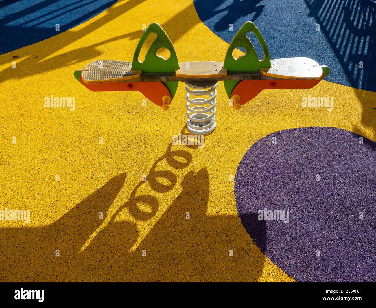 Rocker swing on a playground with a brightly colored rubber floor Stock ...