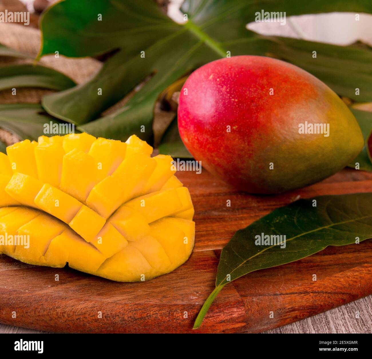 Mango. Tropical Fruits. On a wooden background. Blurred background ...