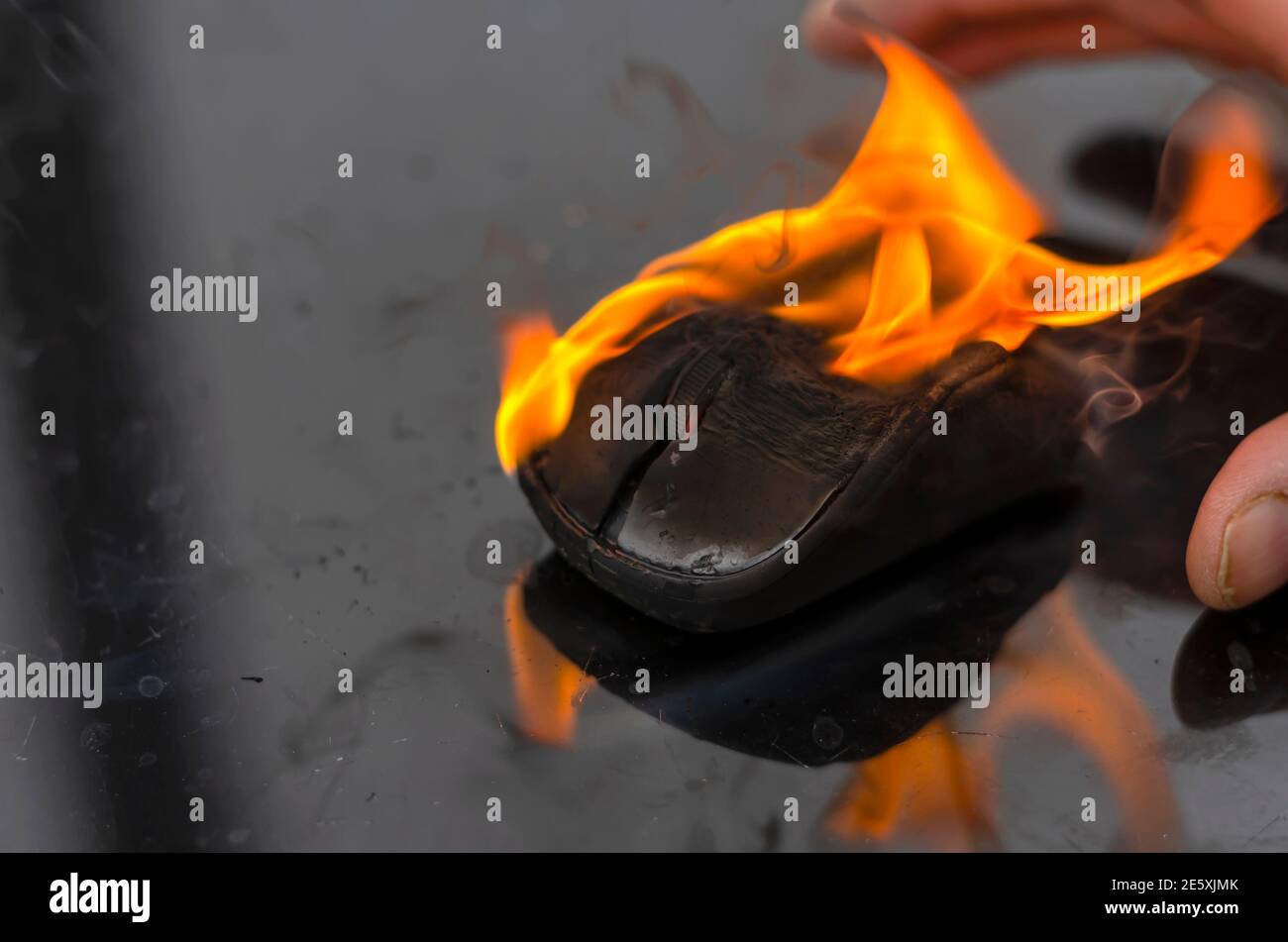 Household electrical appliance fire concept. Wireless computer mouse is ...