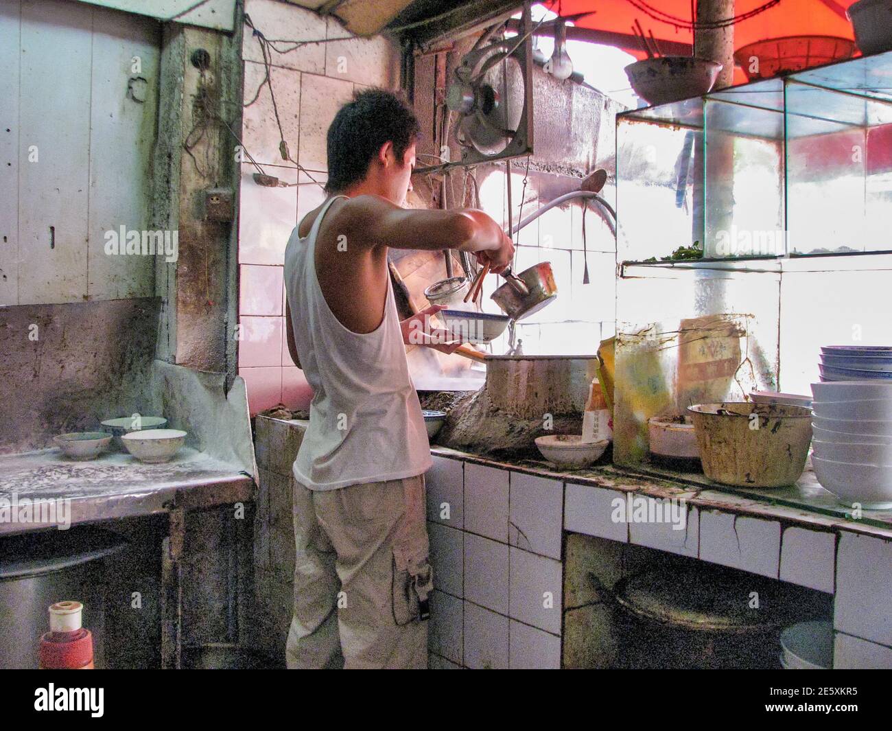 Chinese chef in a sidewalk noodle stand in Shanghai, China Stock Photo ...
