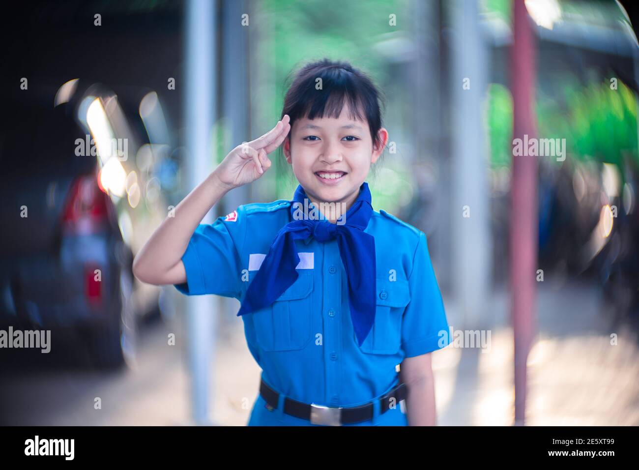 Asian uniform scout girl raise three fingers to respect with beautiful ...