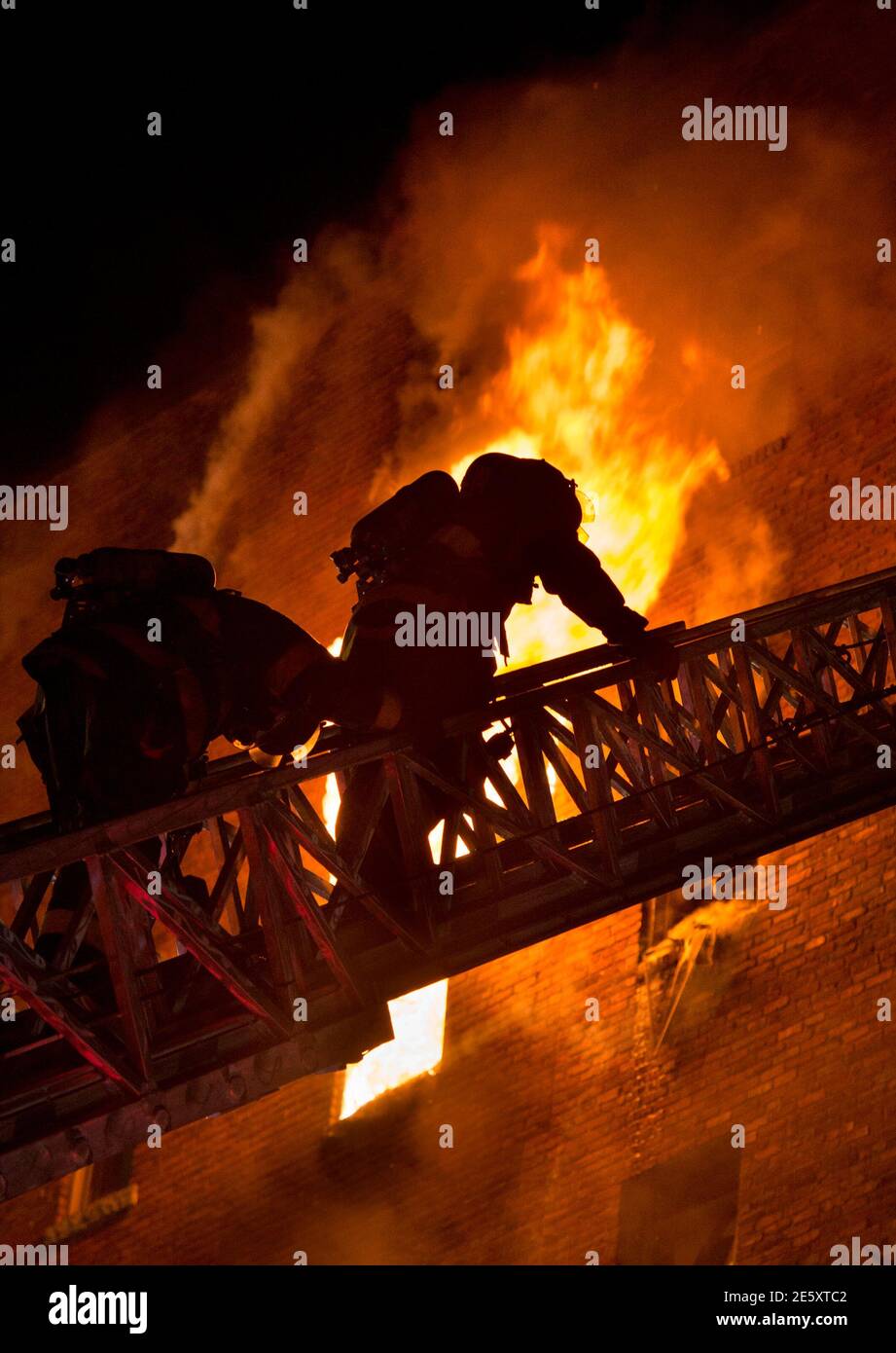 Firefighters climb ladder hi-res stock photography and images - Alamy