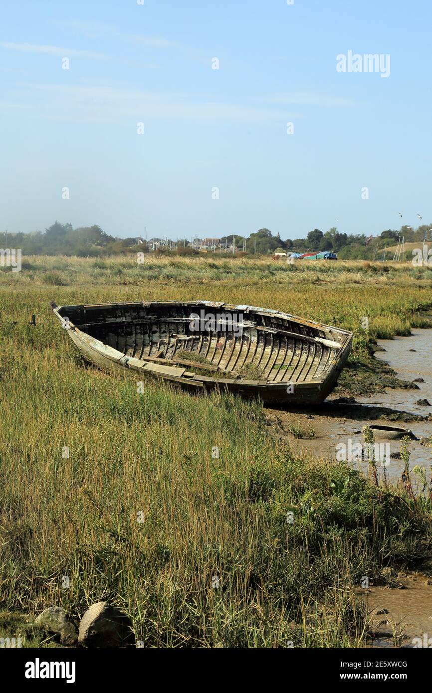 View of abandoned boat on Faversham Creek at low tide from Ham Marshes ...