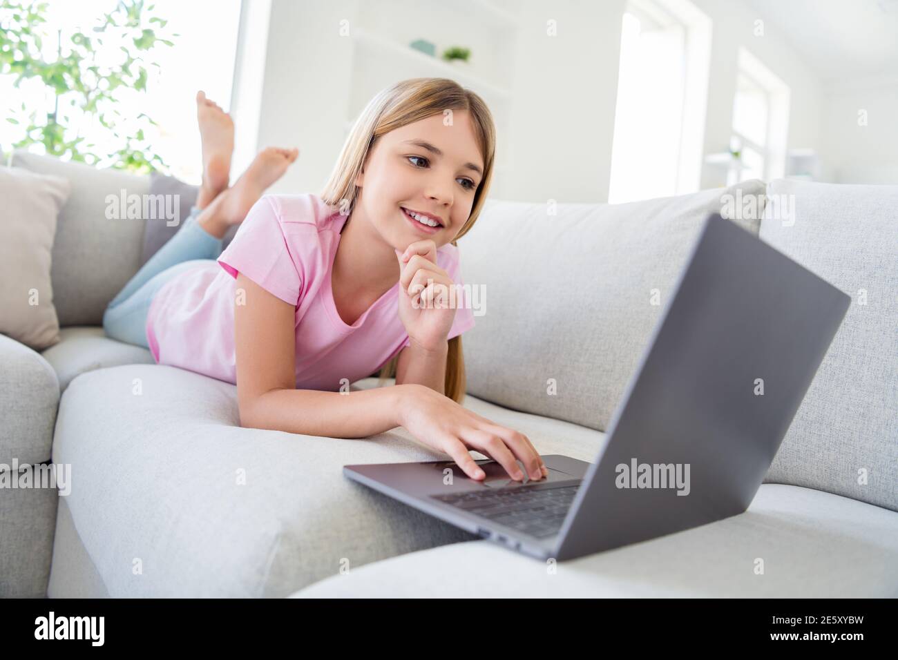 Full length photo of positive girl kid study remote use laptop have ...