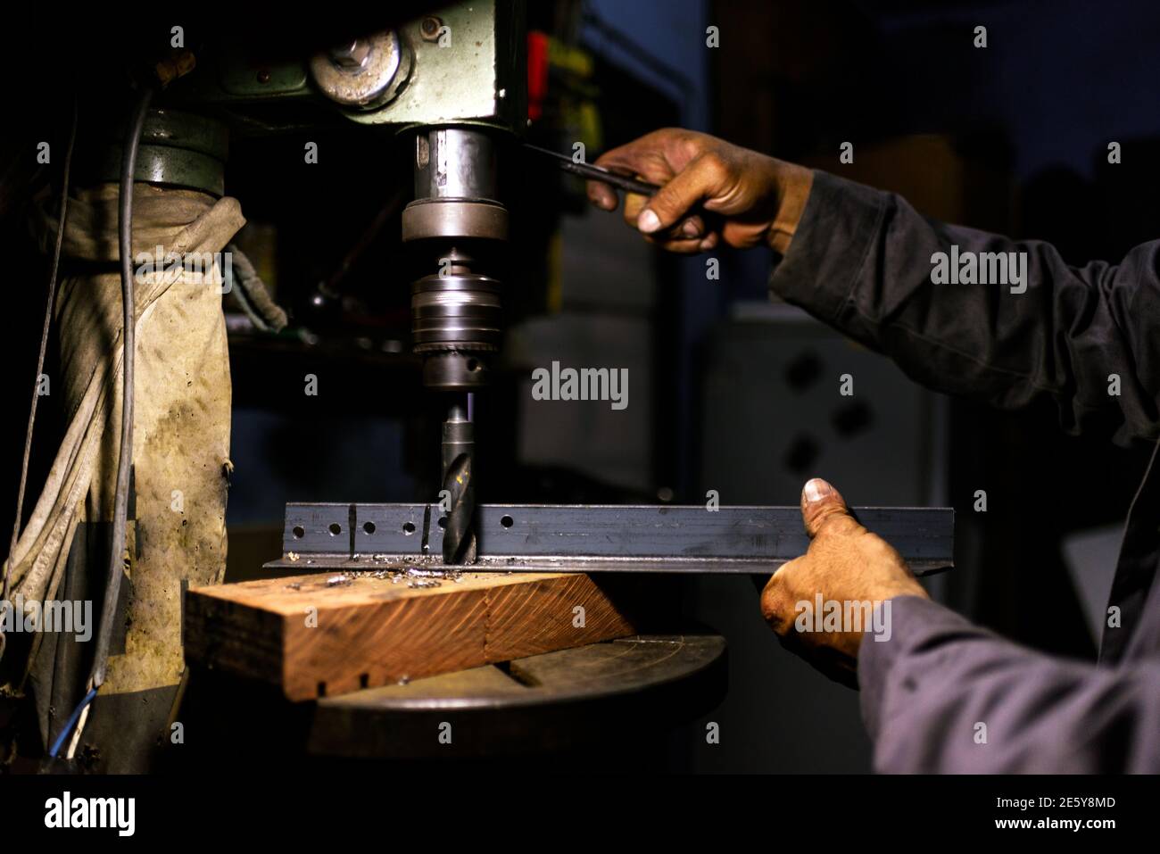 Stock photo of anonymous worker using drilling machine for metal in his ...