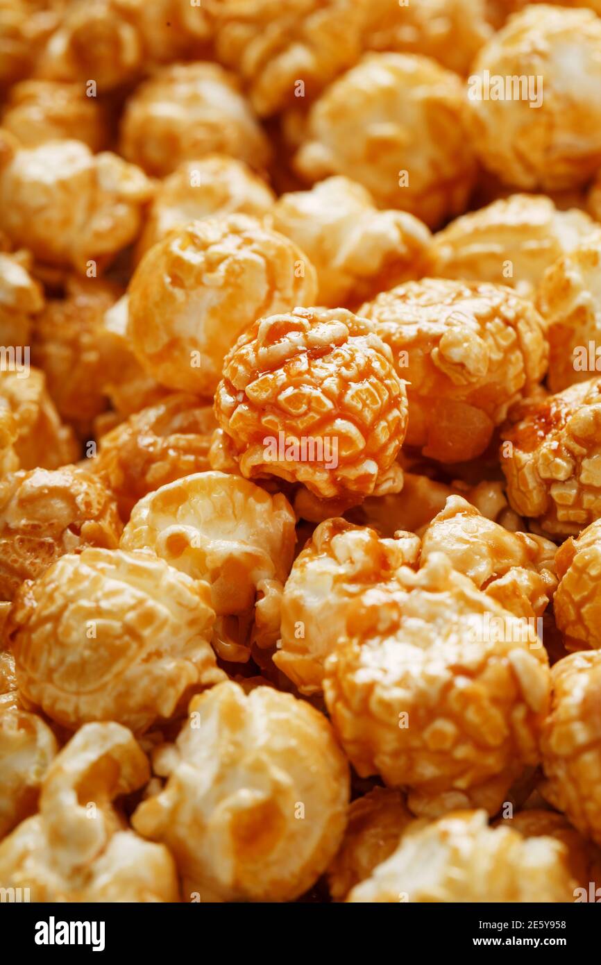 Popcorn in caramel glaze close-up as a background. Delicious praise for ...