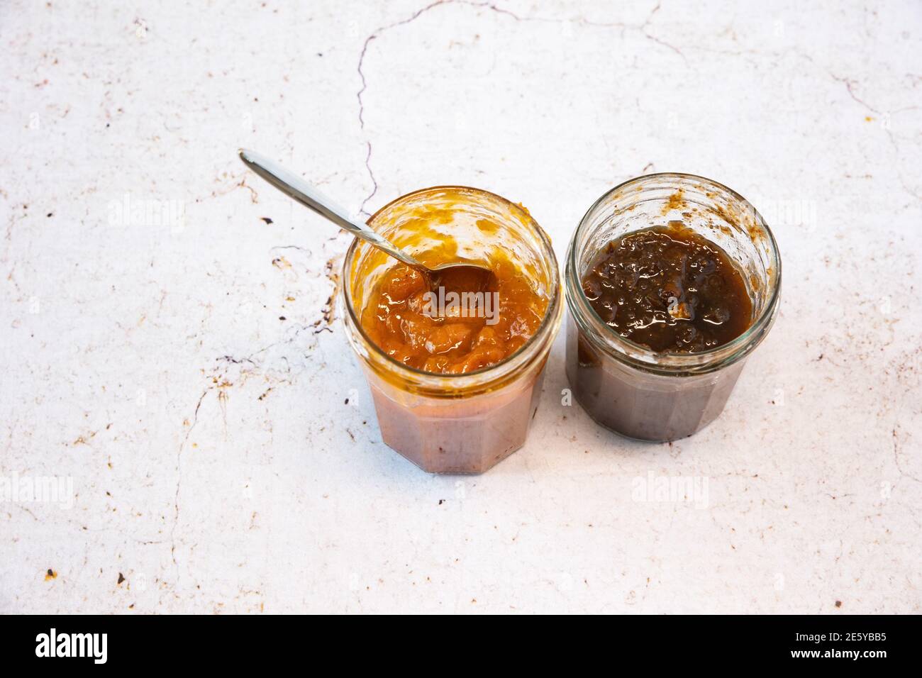 Two jars of homemade jams, one with apricot and the other with figs ...