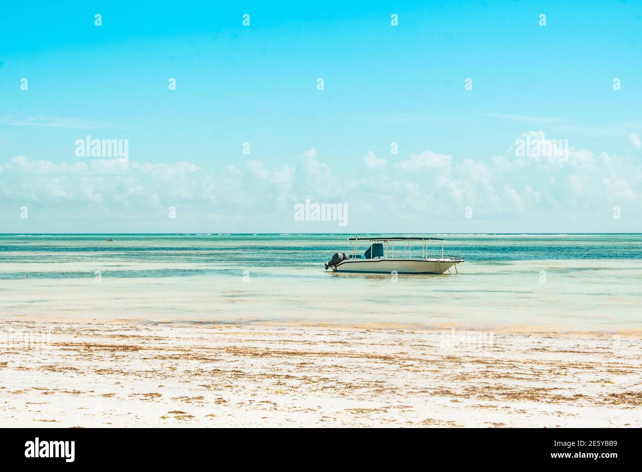 Small motor boat on the shallows on the beach Stock Photo - Alamy