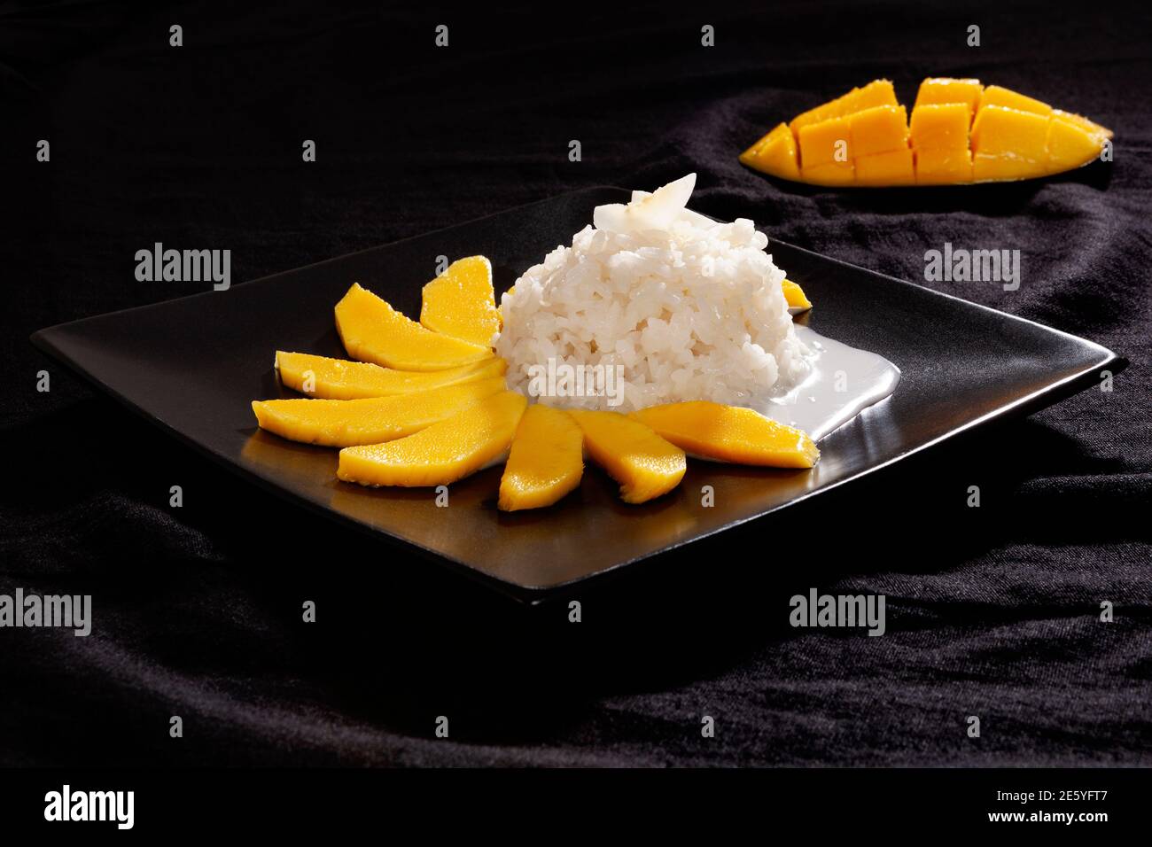 Khao niew mamuang, Mango sticky rice, delicious Thai dessert on black background Stock Photo - Alamy