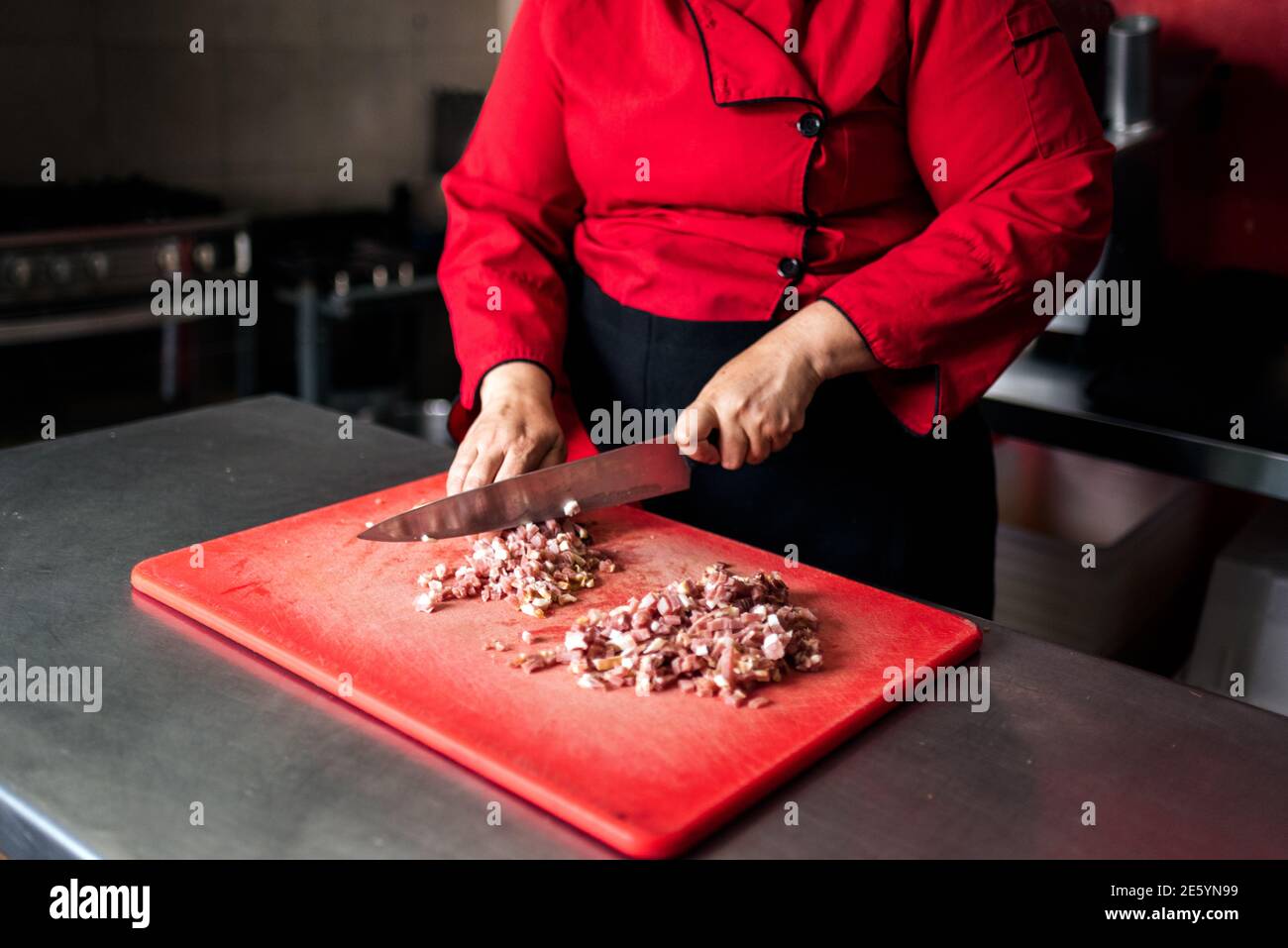 Stock photo of unrecognized chef working in the kitchen chopping meat ...
