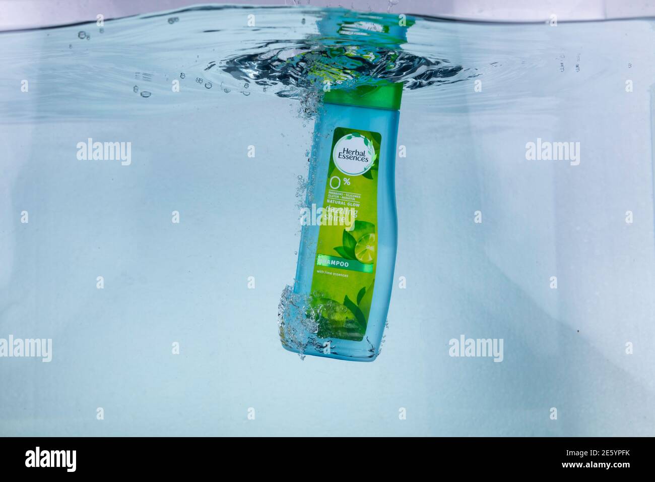 Hi-speed shot of a bottle of Herbal Essence shampoo dropping into water ...