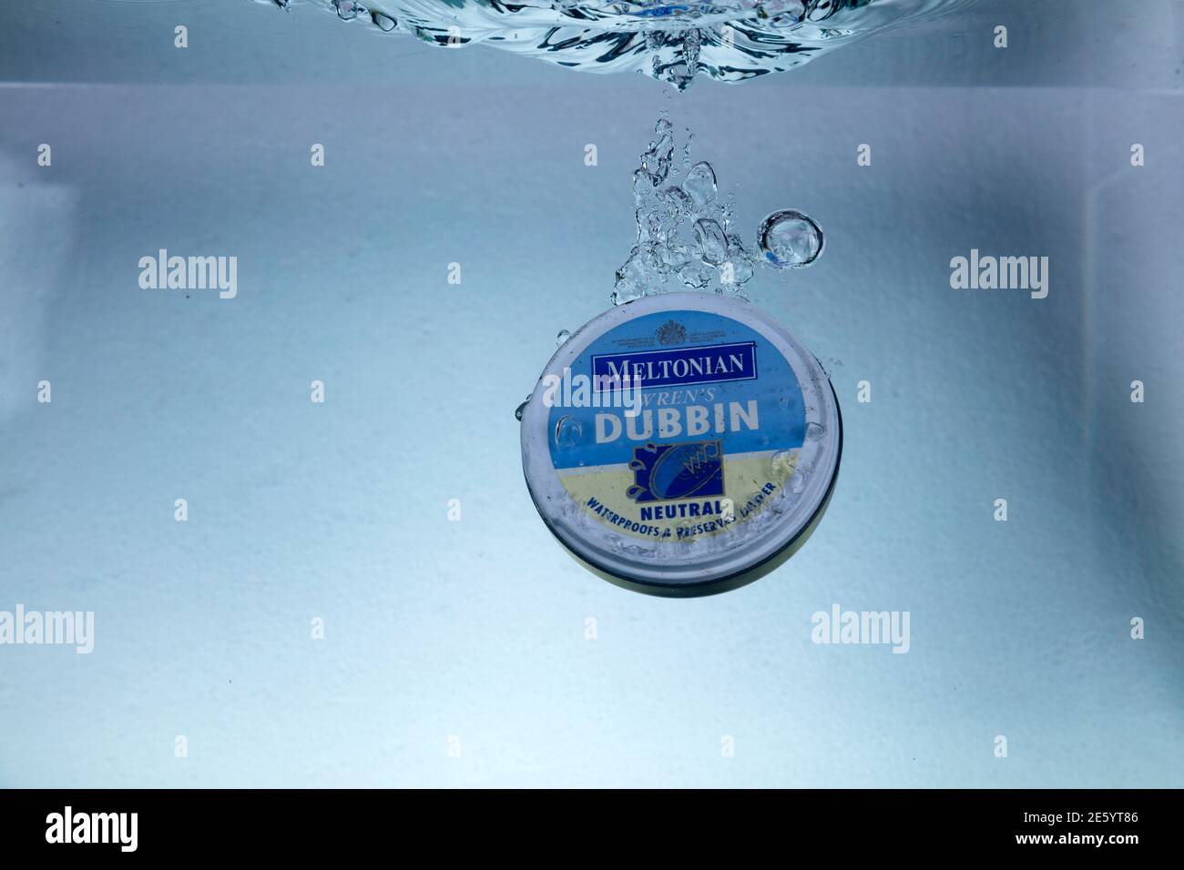Hi-speed shot of a tin of Dubbin dropping into water. Ultra hi-speed of ...