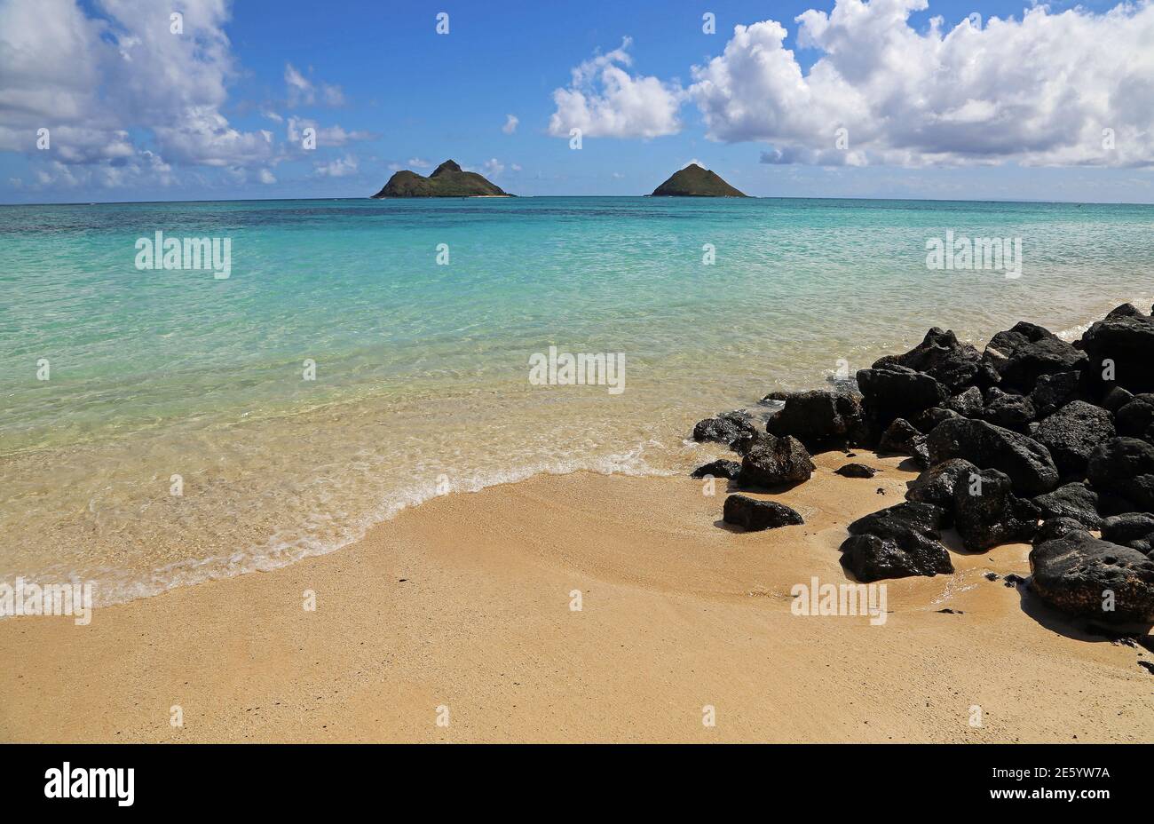 Black rocks on Lanikai Beach - Oahu, Hawaii Stock Photo - Alamy