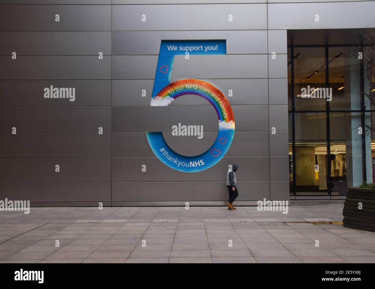A man walks past a Thank You NHS message at 5 Broadgate, City of London ...