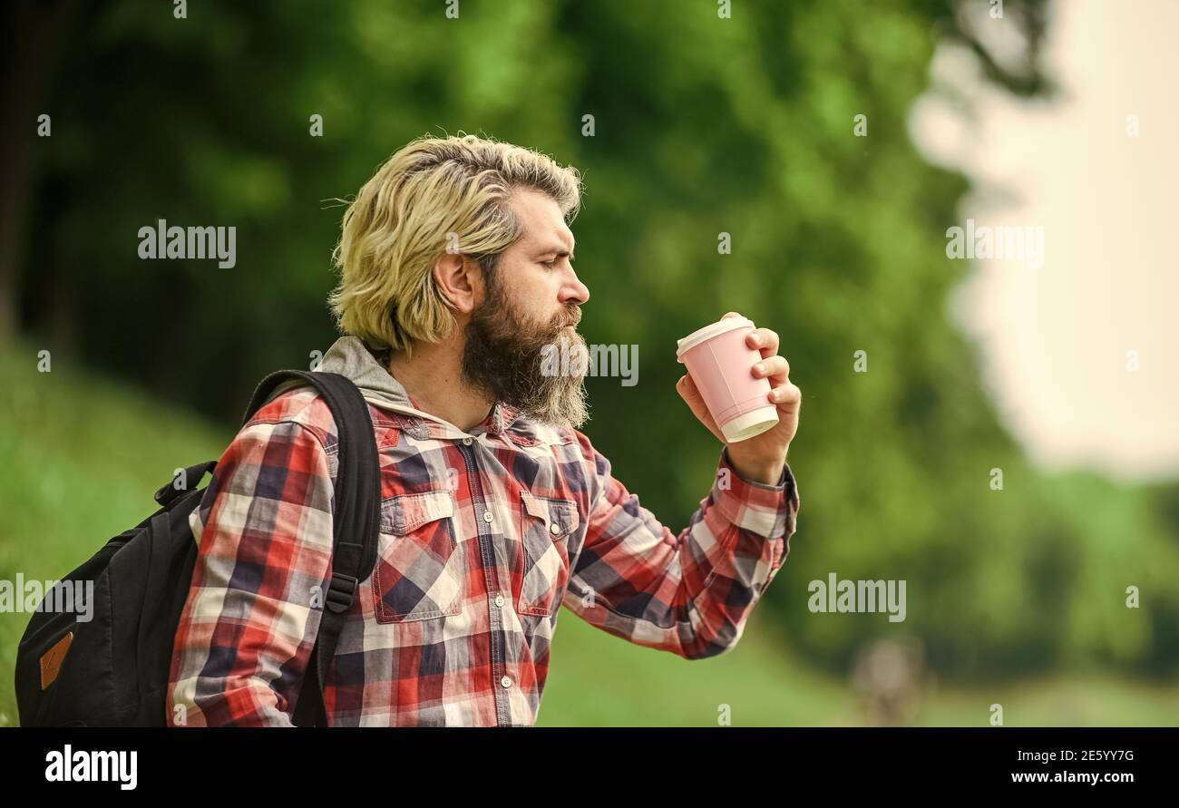 Inspired handsome hipster. Drink tea or coffee. Man with cup outdoors ...