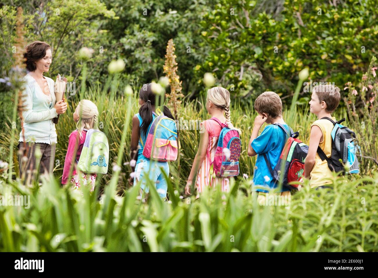 Young teacher with children on nature field trip Stock Photo - Alamy
