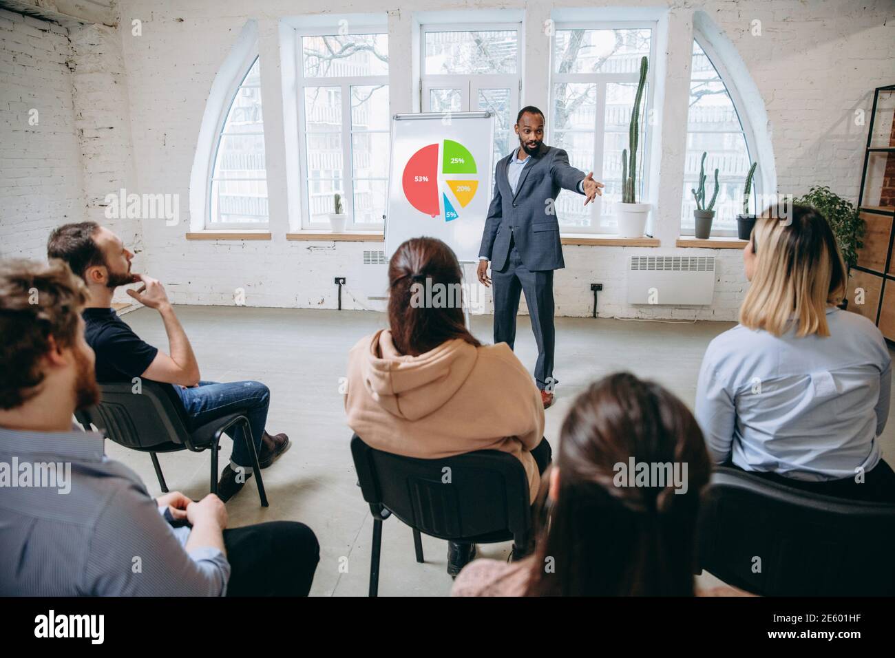 Speech. Male speaker giving presentation in hall at university workshop ...