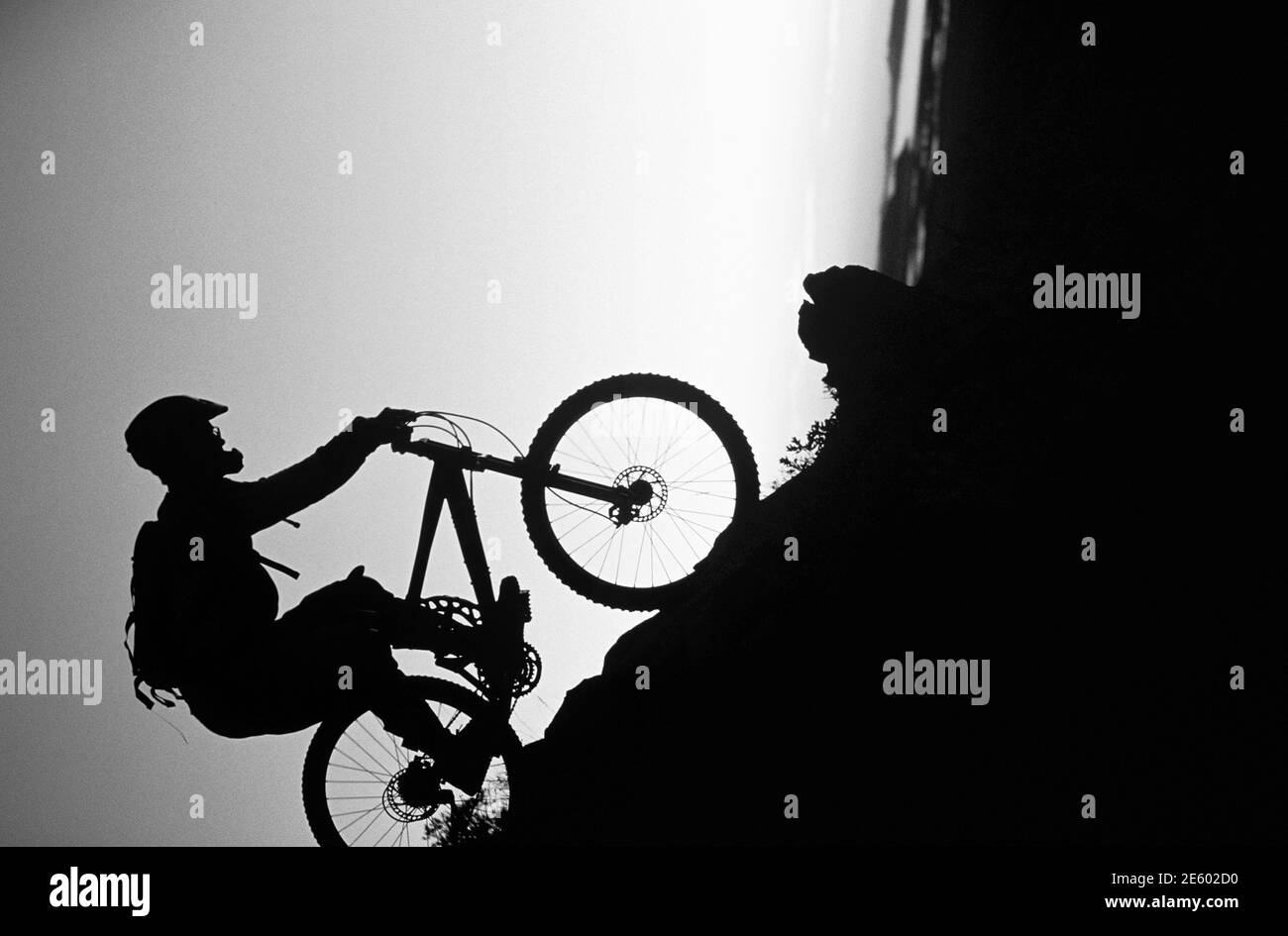 Black and white photo of mountain biker riding down slope Stock Photo ...