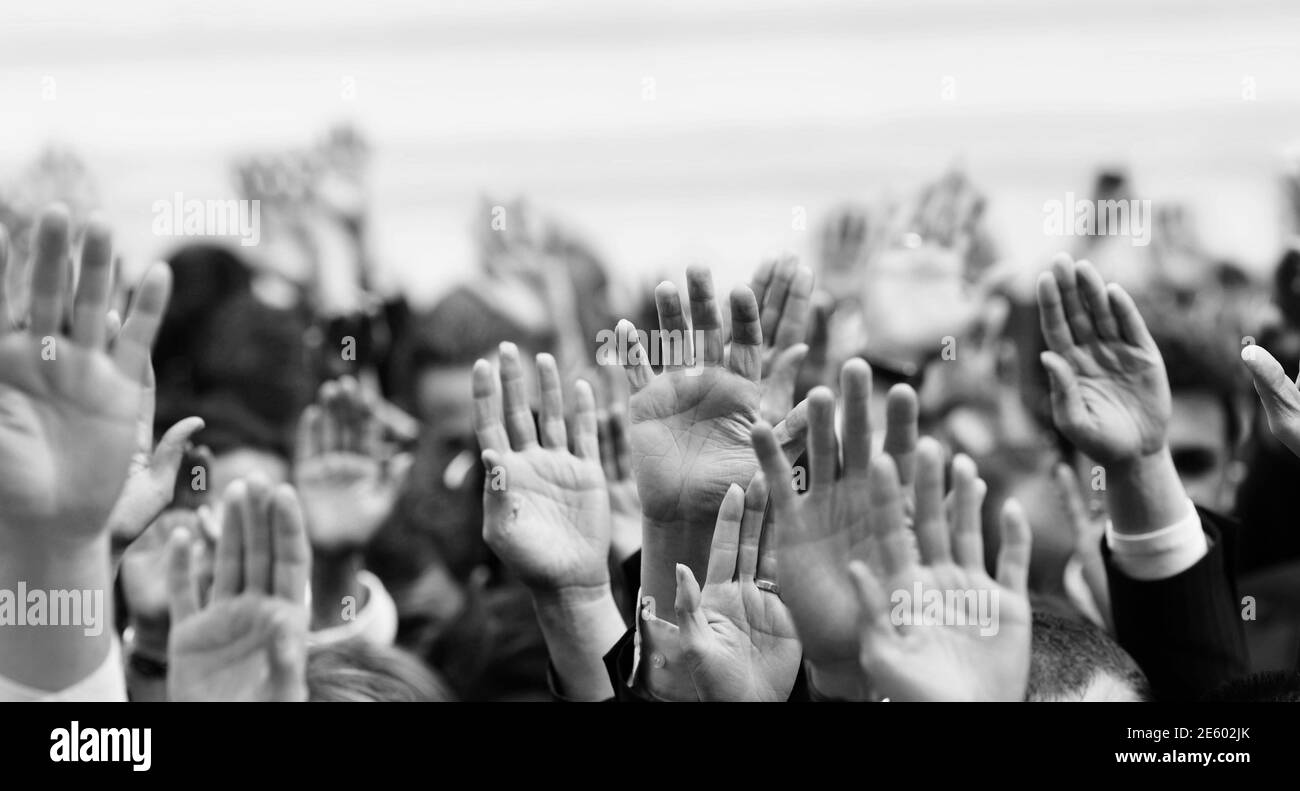 Black and white photo of people raising hands Stock Photo - Alamy