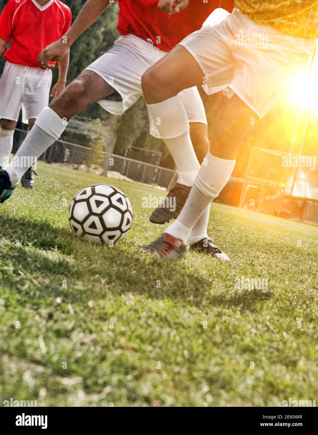 Low angle view of football players tackling Stock Photo - Alamy
